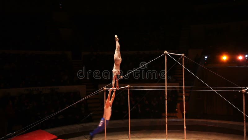 Acrobat Performs Exercises on the Bar in the Circus Arena Stock Footage ...