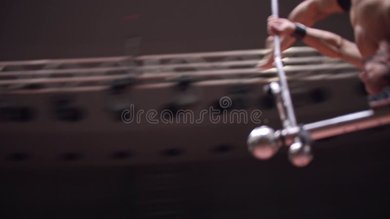 An Acrobatic Man Rotating Upside Down on the Flying Bar at Circus Stock ...