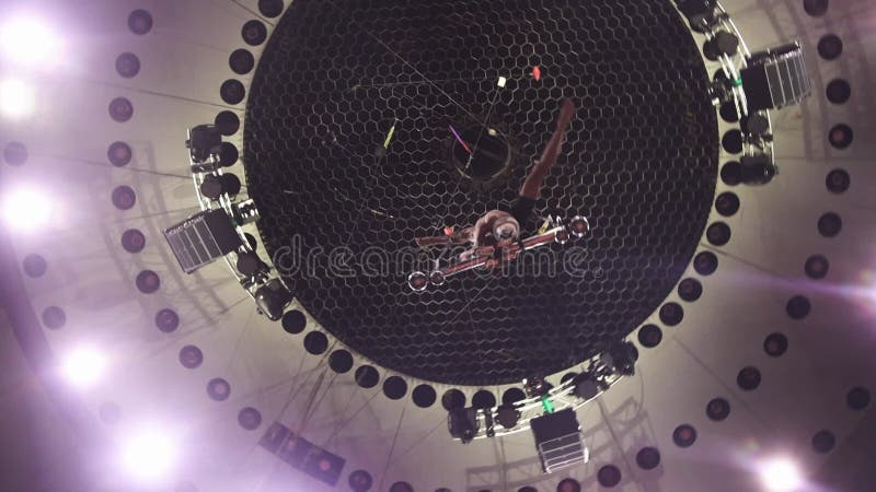 An Acrobatic Man Rotating Upside Down on the Flying Bar at Circus Stock ...