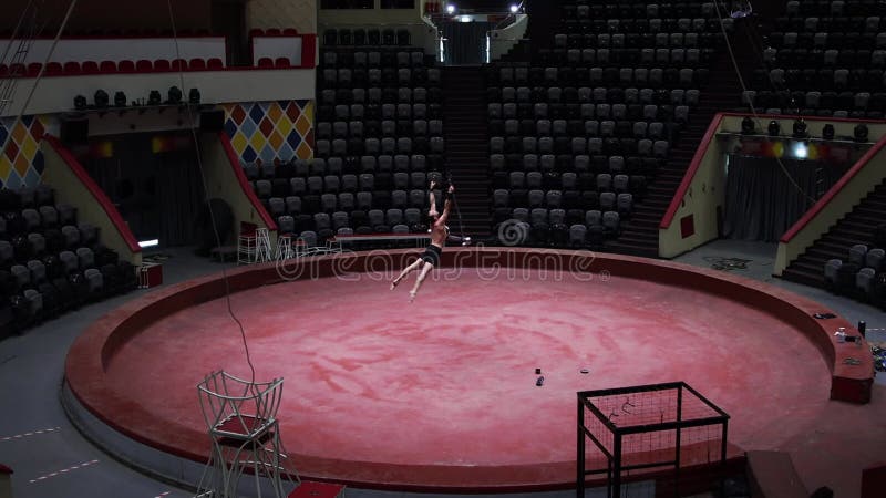 An Acrobatic Man Training His Performance on the Flying Bar at Circus ...