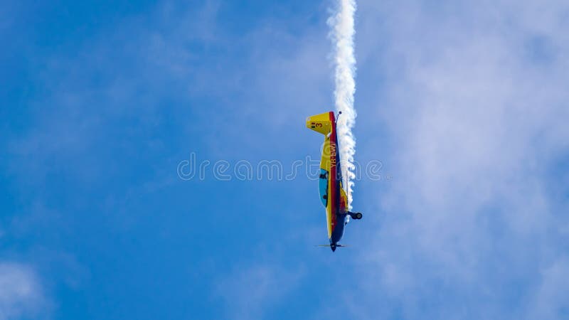An Acrobatic Plane, Flying in the Blue Sky with White Clouds, Doing ...