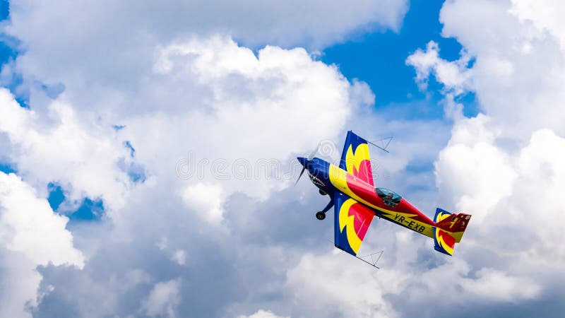 An Acrobatic Plane, Flying in the Blue Sky with White Clouds, Doing ...