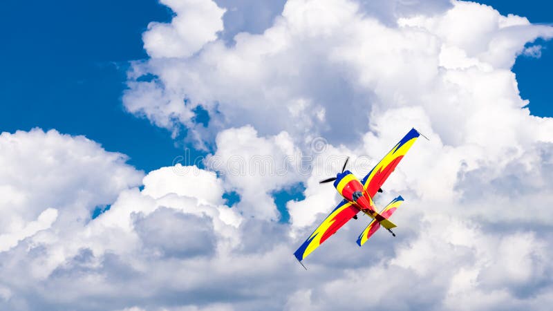 An Acrobatic Plane, Flying in the Blue Sky with White Clouds, Doing ...