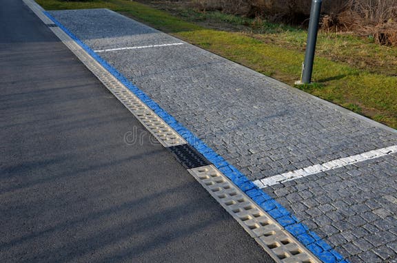 Across the Path There is a Channel with a Metal Grid for Drainage Stock ...