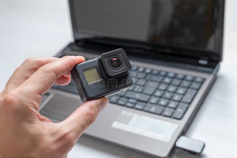 Action Camera in Hand. Laptop in Background Stock Image - Image of ...