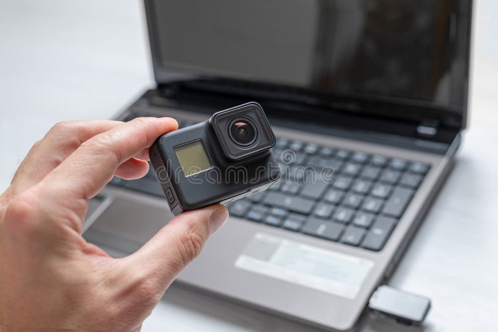 Action Camera in Hand. Laptop in Background Stock Image - Image of ...