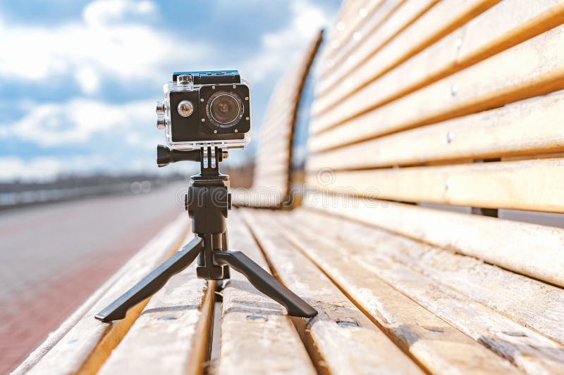 Action Camera Stands on a Wooden Bench. Blue Sky Background Stock Photo ...