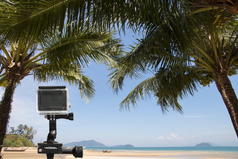 Action Camera on Tripod with Tropical Beach and Coconut Palm Tree Stock ...