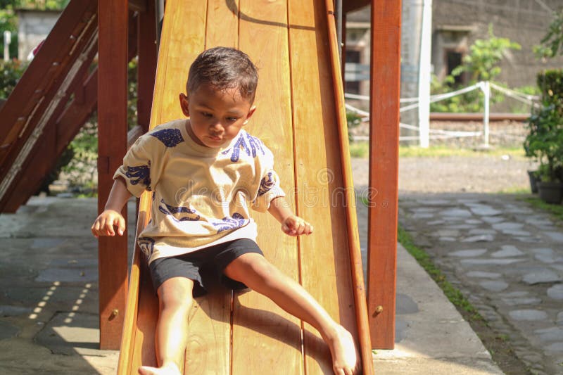 Active boy sliding down stock photo. Image of human - 374517298