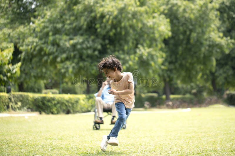 Active Boy Playing in Park stock photo. Image of young - 371572210