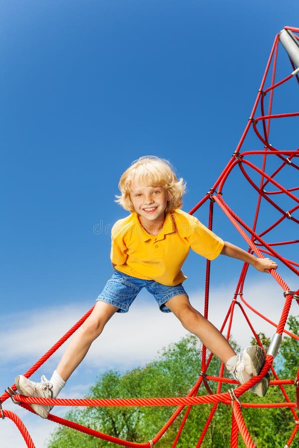 Kids Standing in a Row on Red Ropes of Playground Stock Photo - Image ...