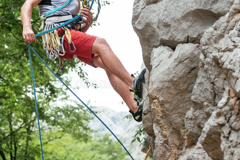 Active Climber Middle Age Man in Protective Helmet while Abseiling from ...