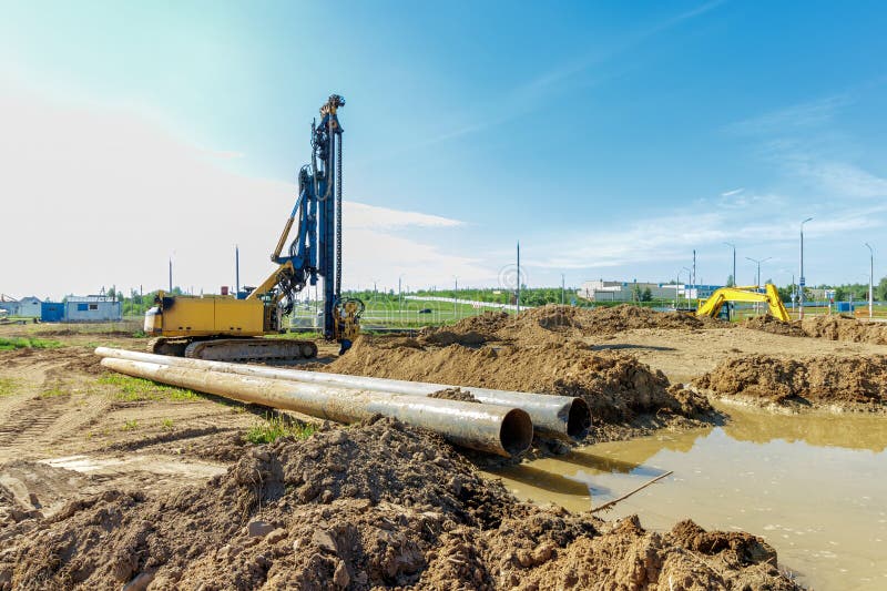 Construction Site with Excavator and Pipes in Action Stock Image ...
