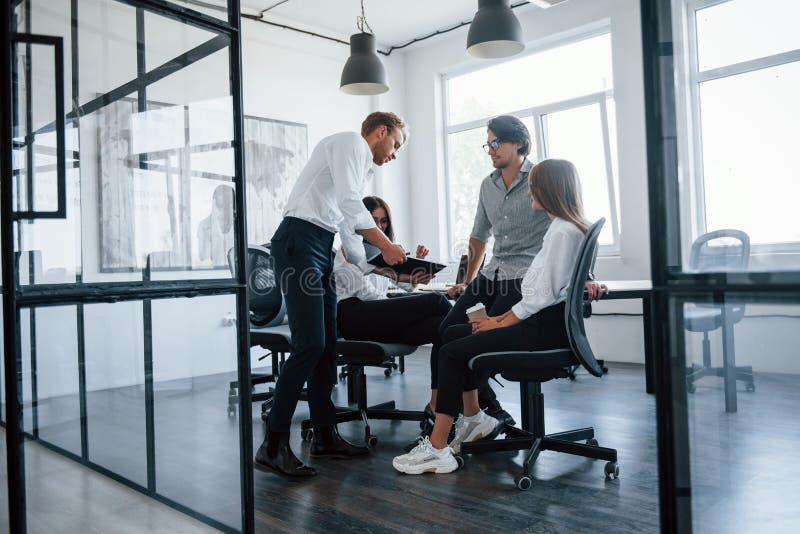 Active Conversation. Young Business People in Formal Clothes Working in ...