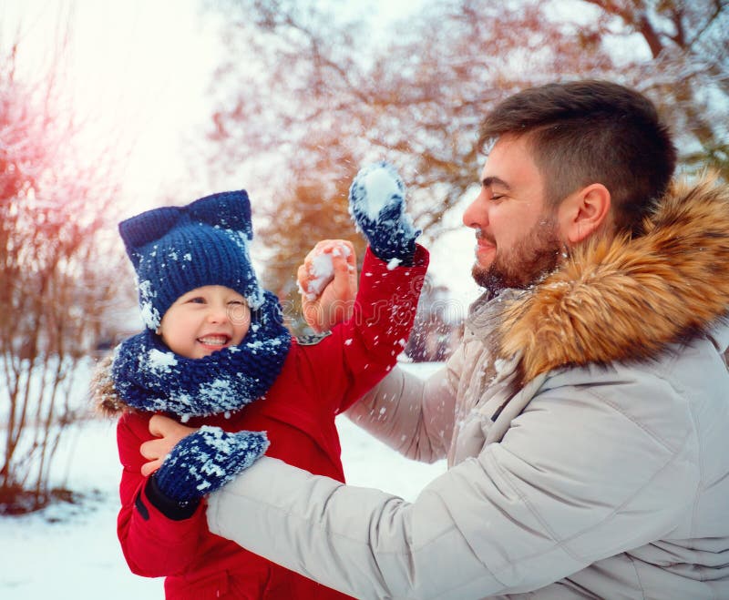Active Father and Son Playing Snowballs in Winter Park Stock Photo ...