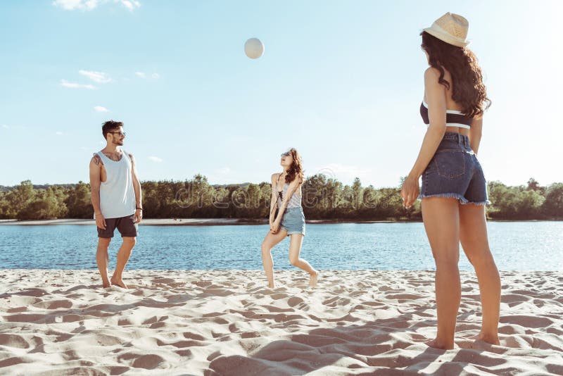 Active Friends Playing Volleyball on Beach Together Stock Image - Image ...