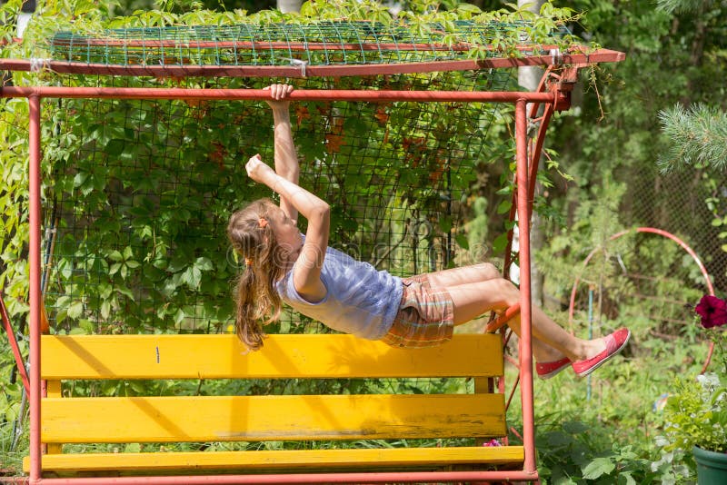 Active girl on a bench stock photo. Image of person - 153342396