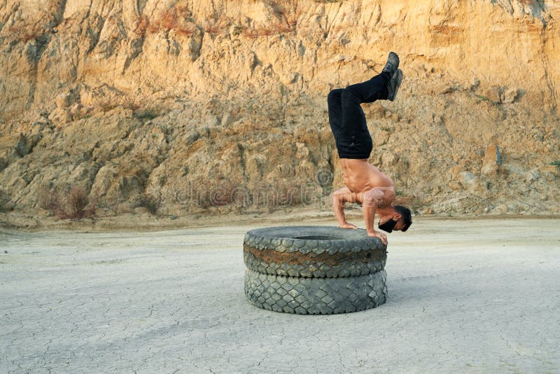 Active Guy Balancing on Tyres while Training Outdoors Stock Image ...