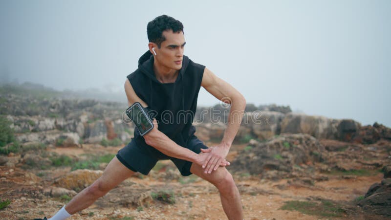 Active Guy Doing Exercise Lunges on Cliff. Focused Athletic Male ...