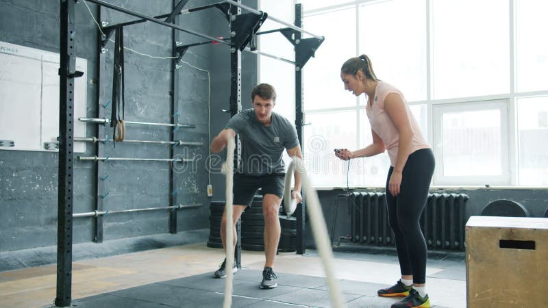 Active Guy Student Doing Ropes Battling Crossfit Exercise Training with ...