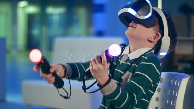 Active Little Boy Enjoying Virtual Reality with Motion Controllers in ...
