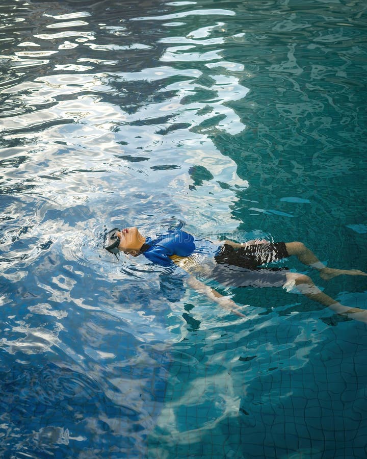 Active Little Girl Floating and Swimming in the Pool. Copyspace Stock ...