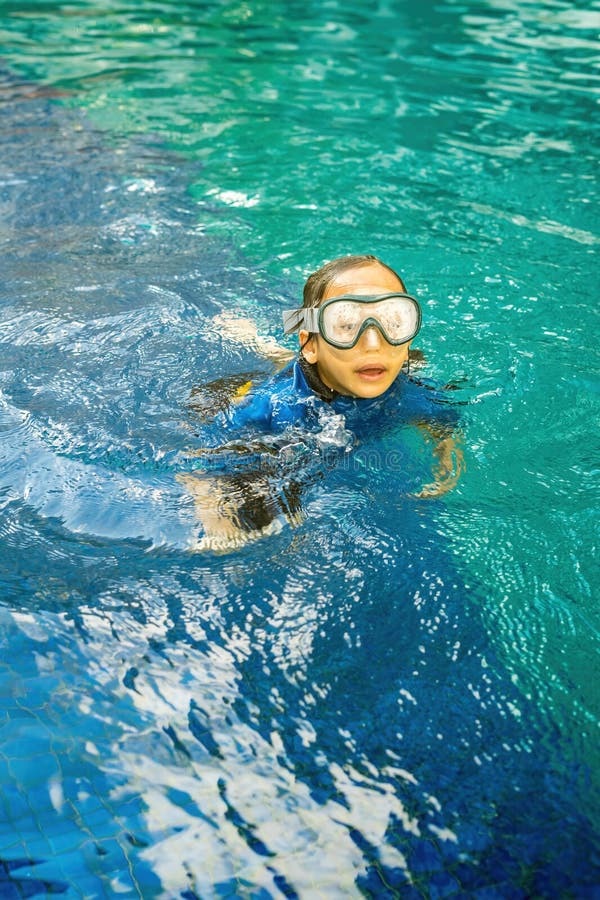 Active Little Girl Floating and Swimming in the Pool. Copyspace Stock ...