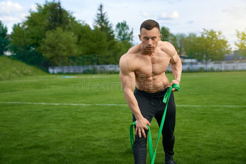 Active Man with Bare Torso Using Rubber Band for Training Stock Image ...