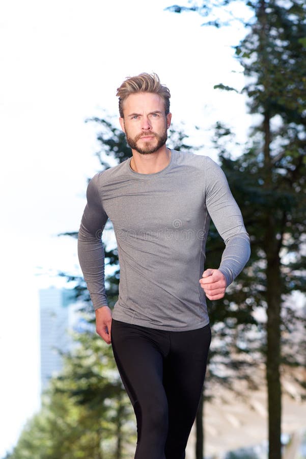 Active man running outside stock photo. Image of cool - 62008836