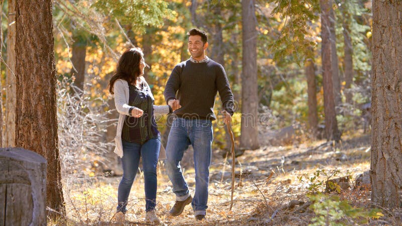 Active Mature Couple Outdoors Enjoying Autumn or Fall Walk in Forest ...