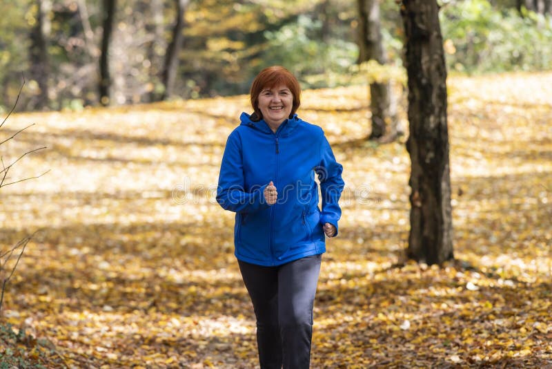 Active Middle-aged Woman Jogs Runs Stock Photo - Image of people ...