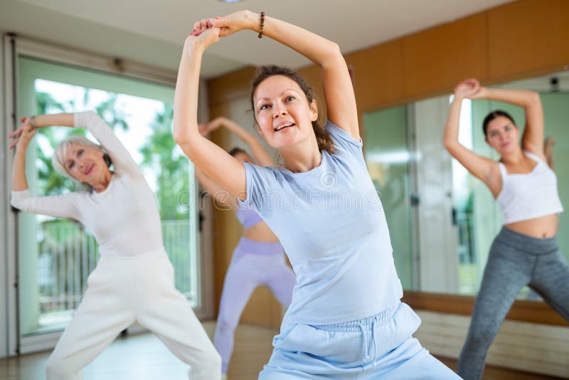 Active Middle-aged Woman Practicing Aerobic Dance in Training Hall ...