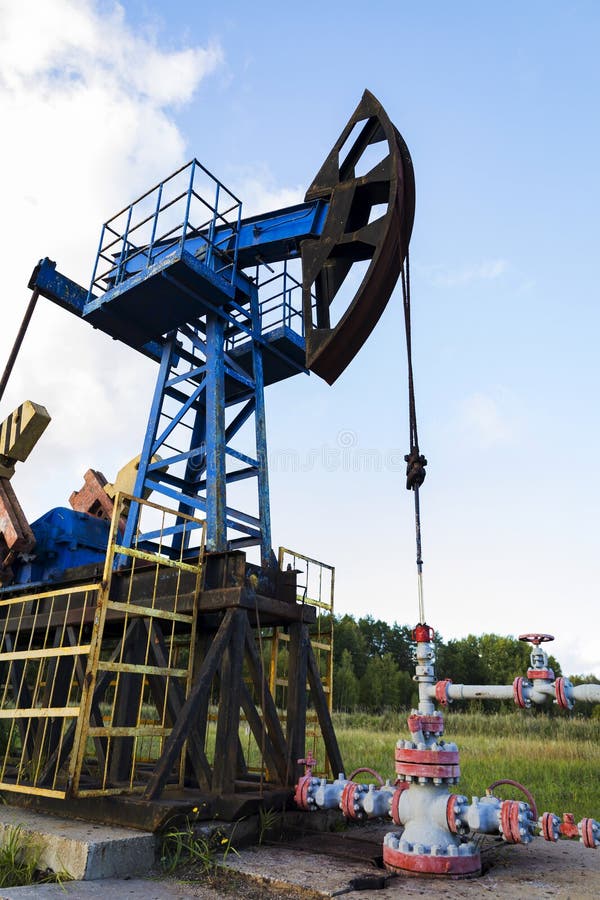 An Active Oil Rig Operating at Sunrise or Sunset. Resource Extraction ...