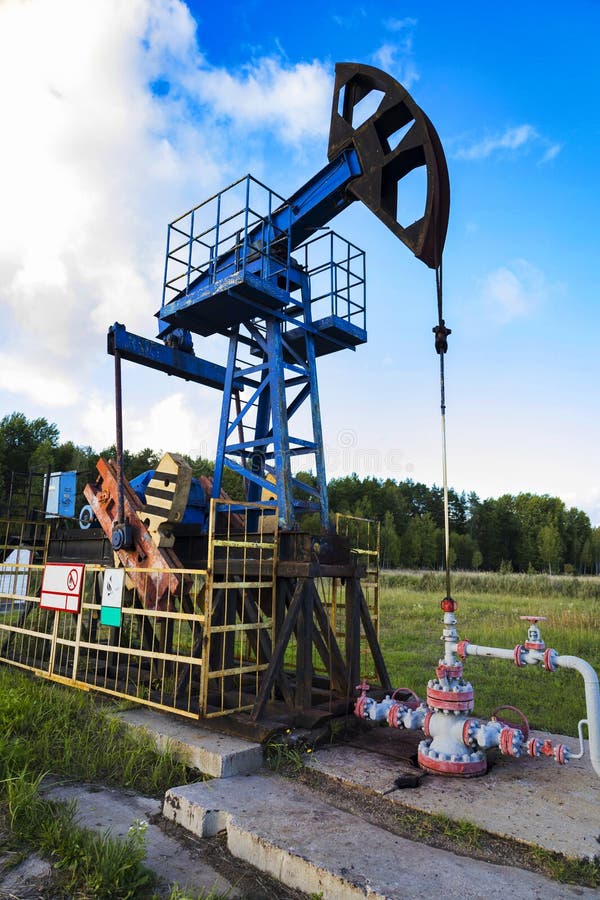 An Active Oil Rig Operating at Sunrise or Sunset. Resource Extraction ...