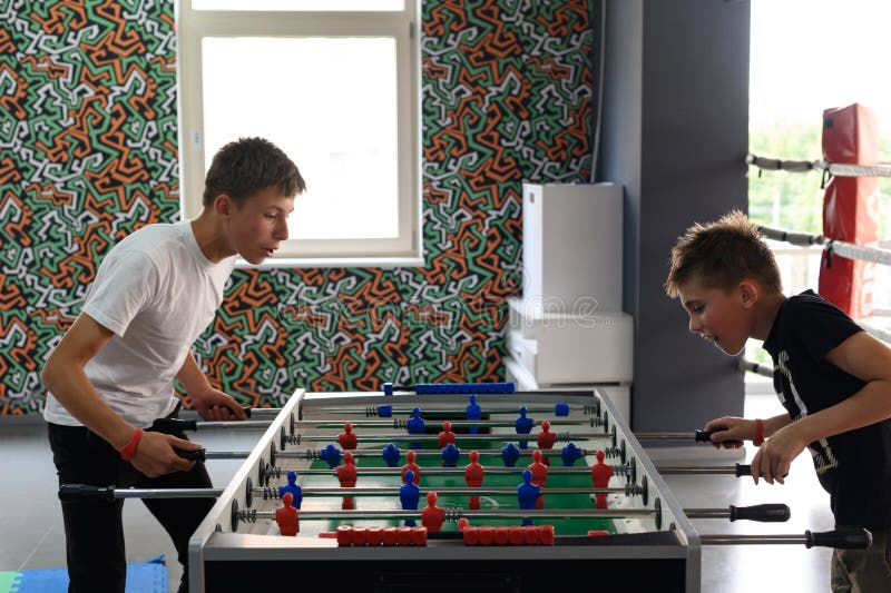 Active Recreation in the Game Room, Children Play Table Football. Stock ...