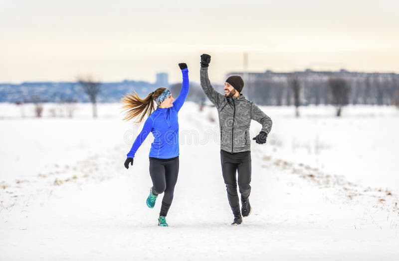 Active Runner Couple Jogging Together in Snowy Path in Nature. Stock ...