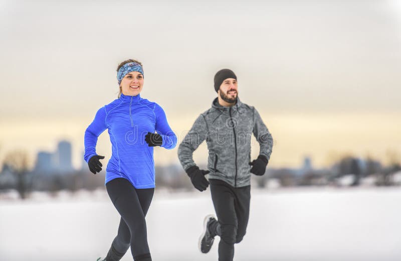 Active Runner Couple Jogging Together in Snowy Path in Nature. Stock ...