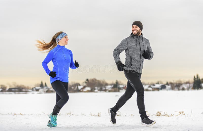 Active Runner Couple Jogging Together in Snowy Path in Nature. Stock ...