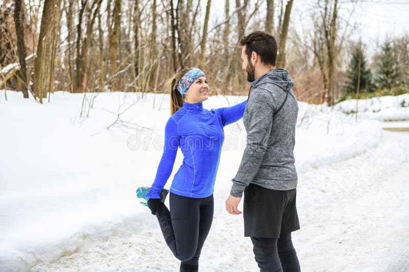 Active Runner Couple Jogging Together in Snowy Path in Nature. Stock ...