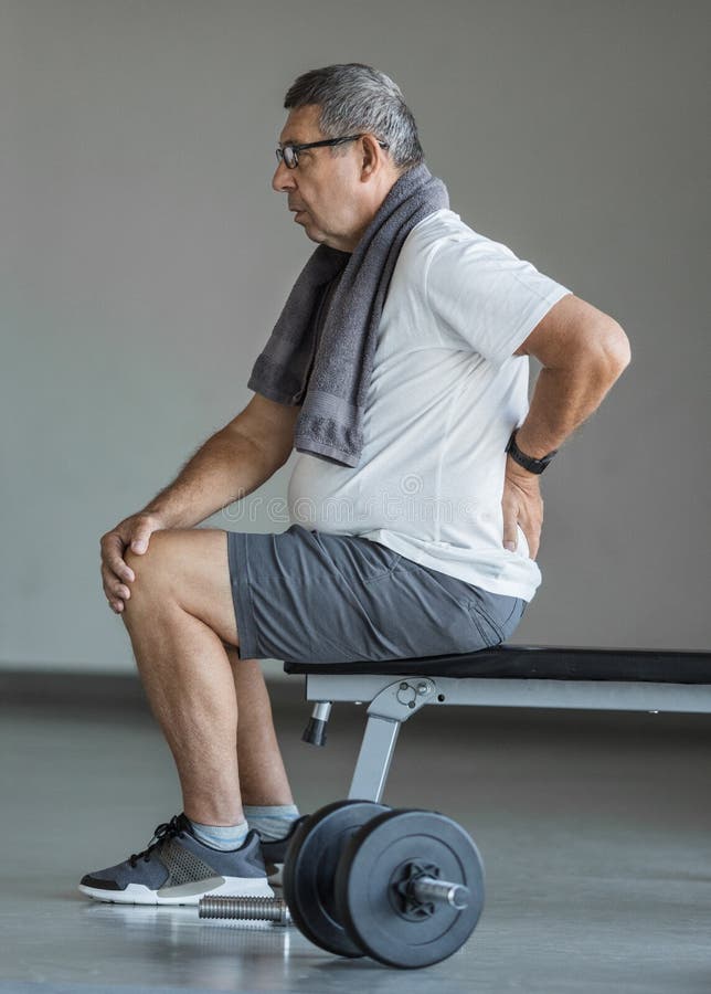 Active Senior in Gym with Back Pain Stock Image - Image of elderly ...
