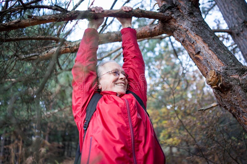Active Senior Woman Happy Hanging from Tree in Forest Stock Image ...