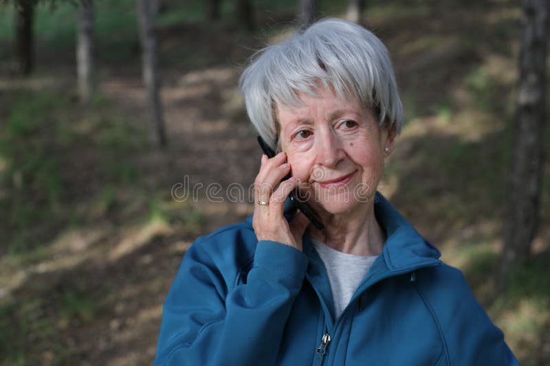 Active Senior Woman Making a Phone Call from the Forest Stock Photo ...