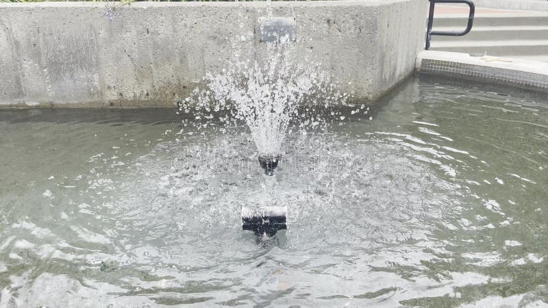 Active Small Water Fountain in the Gray Pool Stock Video - Video of ...