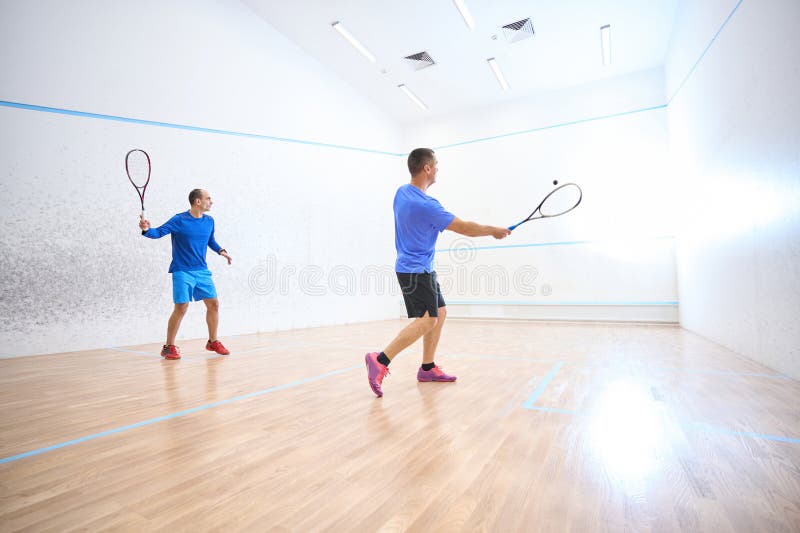 Active Sporty Men Training Together on Squash Court Stock Image - Image ...
