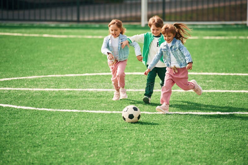 Active Weekend. Kids are Having Fun on the Green Soccer Field Together ...