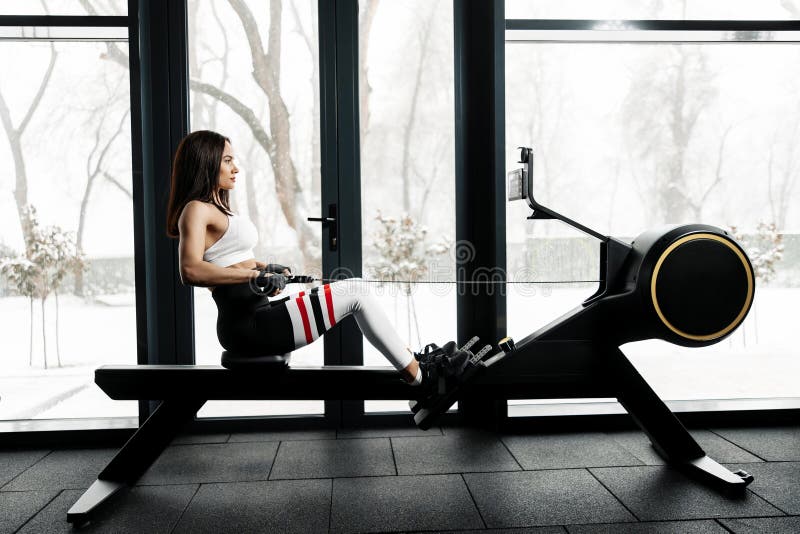 Active Woman Exercising Rowing Machine Gym Near Window Functional ...