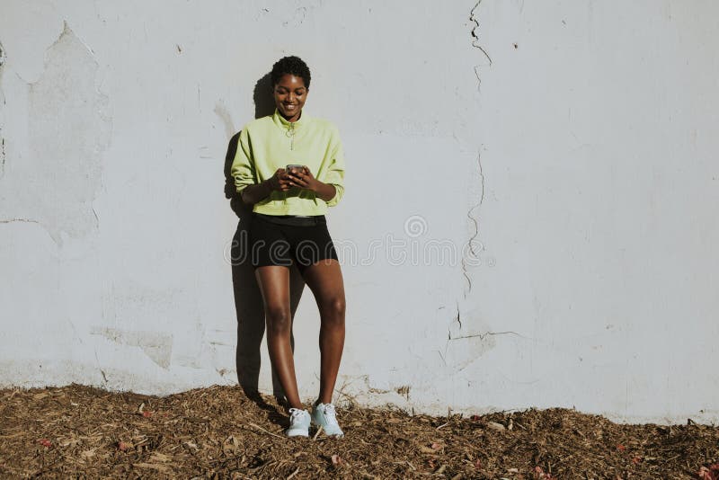 Active Woman Standing by a White Wall Stock Photo - Image of ...