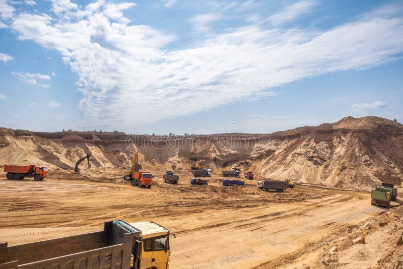 Active Work in a Sand Quarry. Bucket Trucks Load Sand into Trucks Stock ...