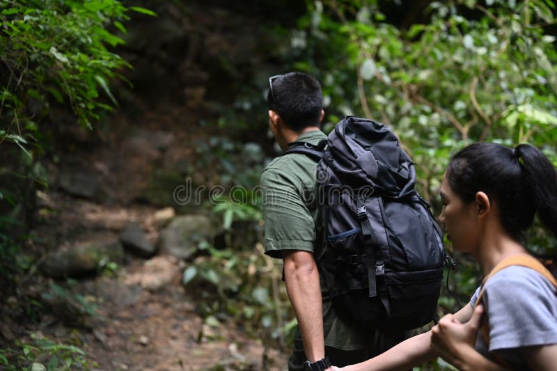 Active Young Couple with Backpack Trekking in Forest, Exploring Nature ...