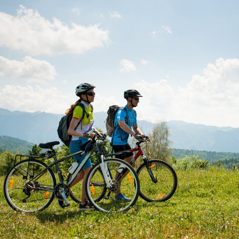 ACTIVE Young Couple Biking on a Forest Road in Mountain on a Spring Day ...